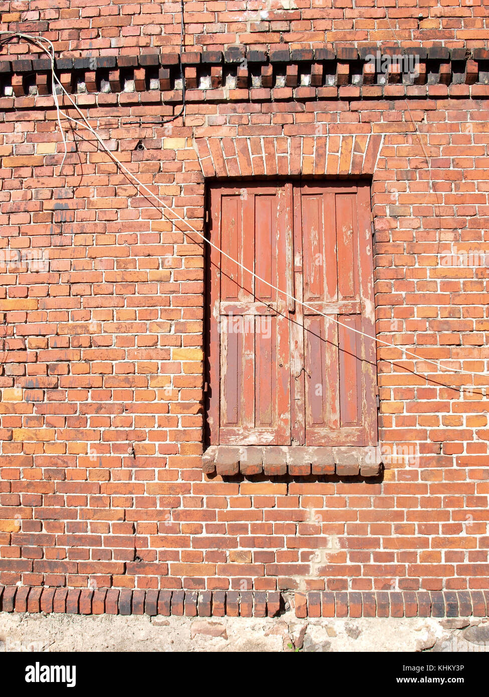 Window with red color wooden shutters in red brick house wall Stock ...