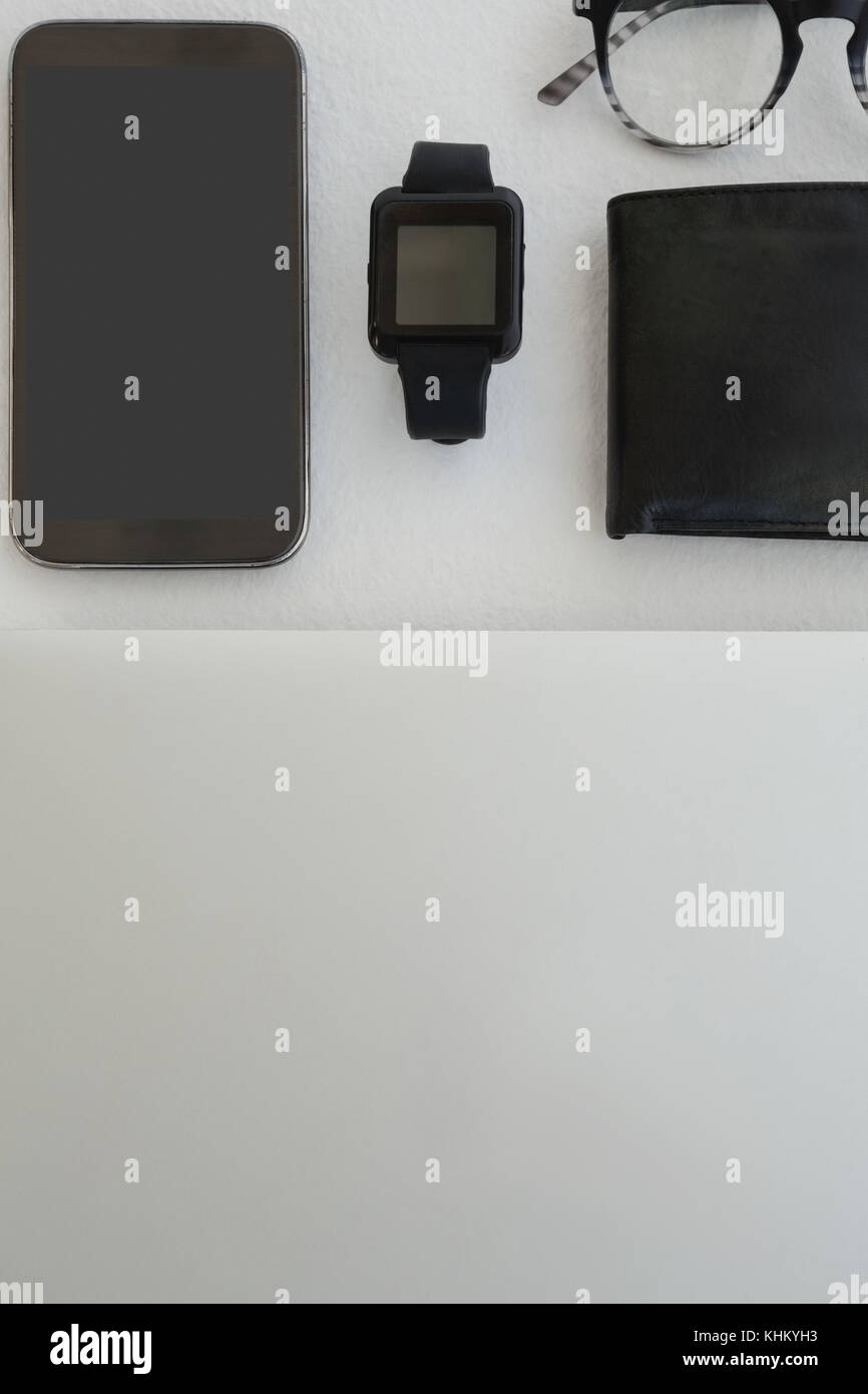 Close-up of various gadgets, spectacles and wallet on white background ...