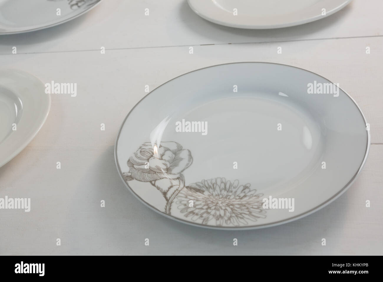 Modern empty plates on white background Stock Photo - Alamy