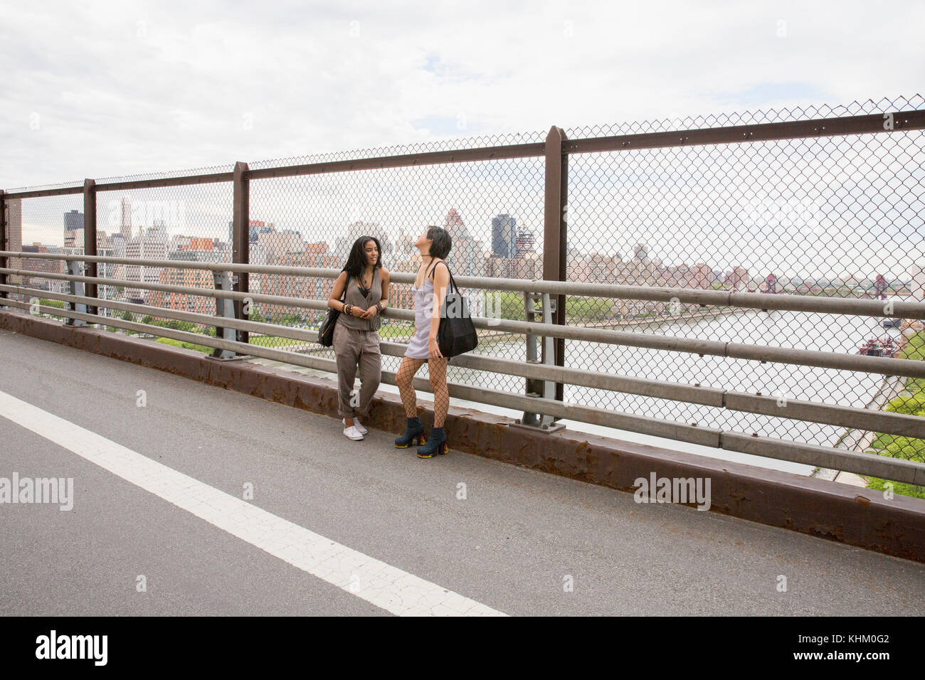 Friends talking on a bridge in Queens, New York Stock Photo - Alamy