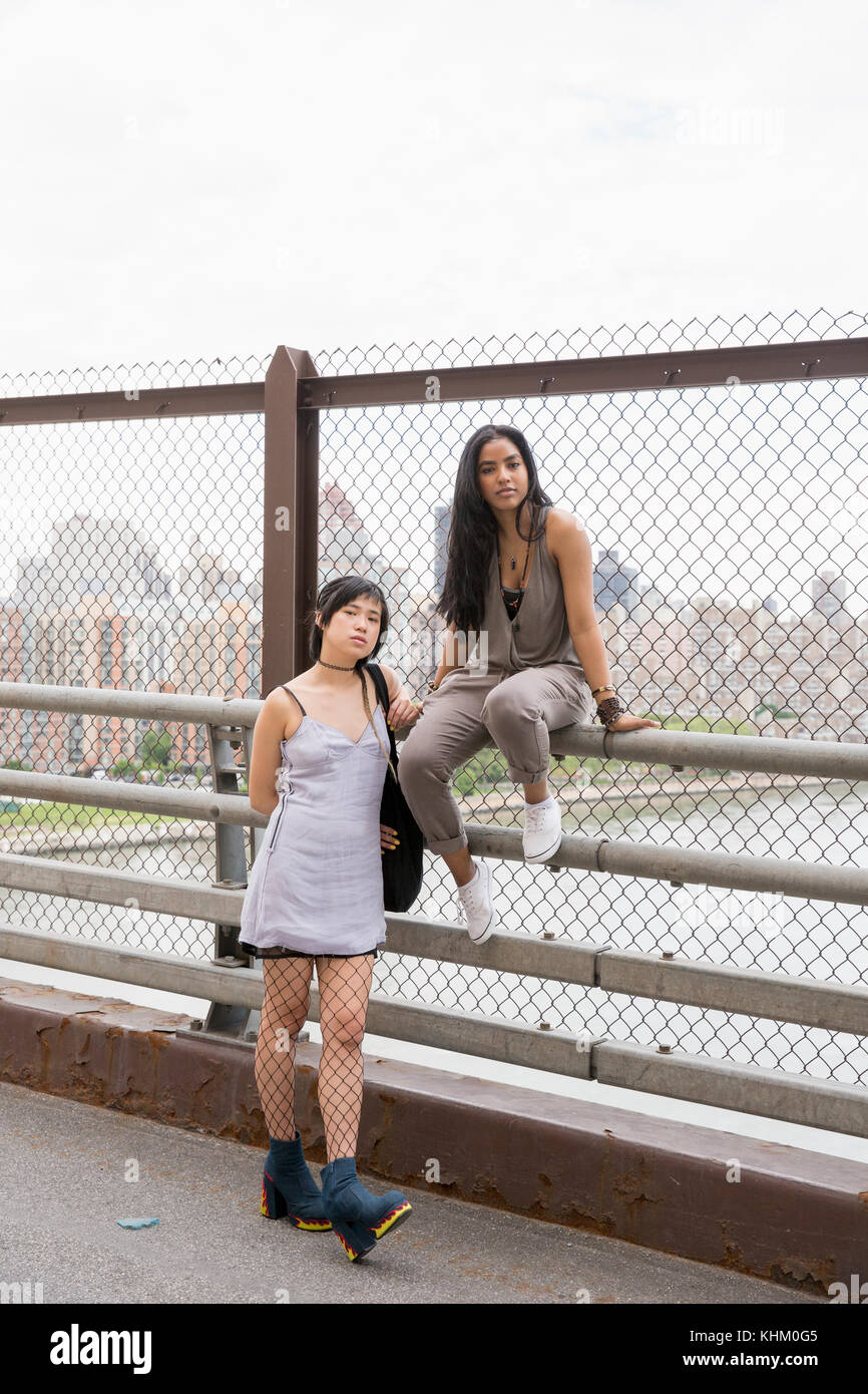 Young women posing on a bridge Stock Photo - Alamy