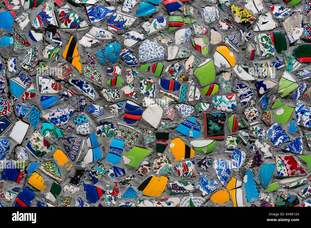 Wall with broken ceramic plates colored fragments Stock Photo - Alamy