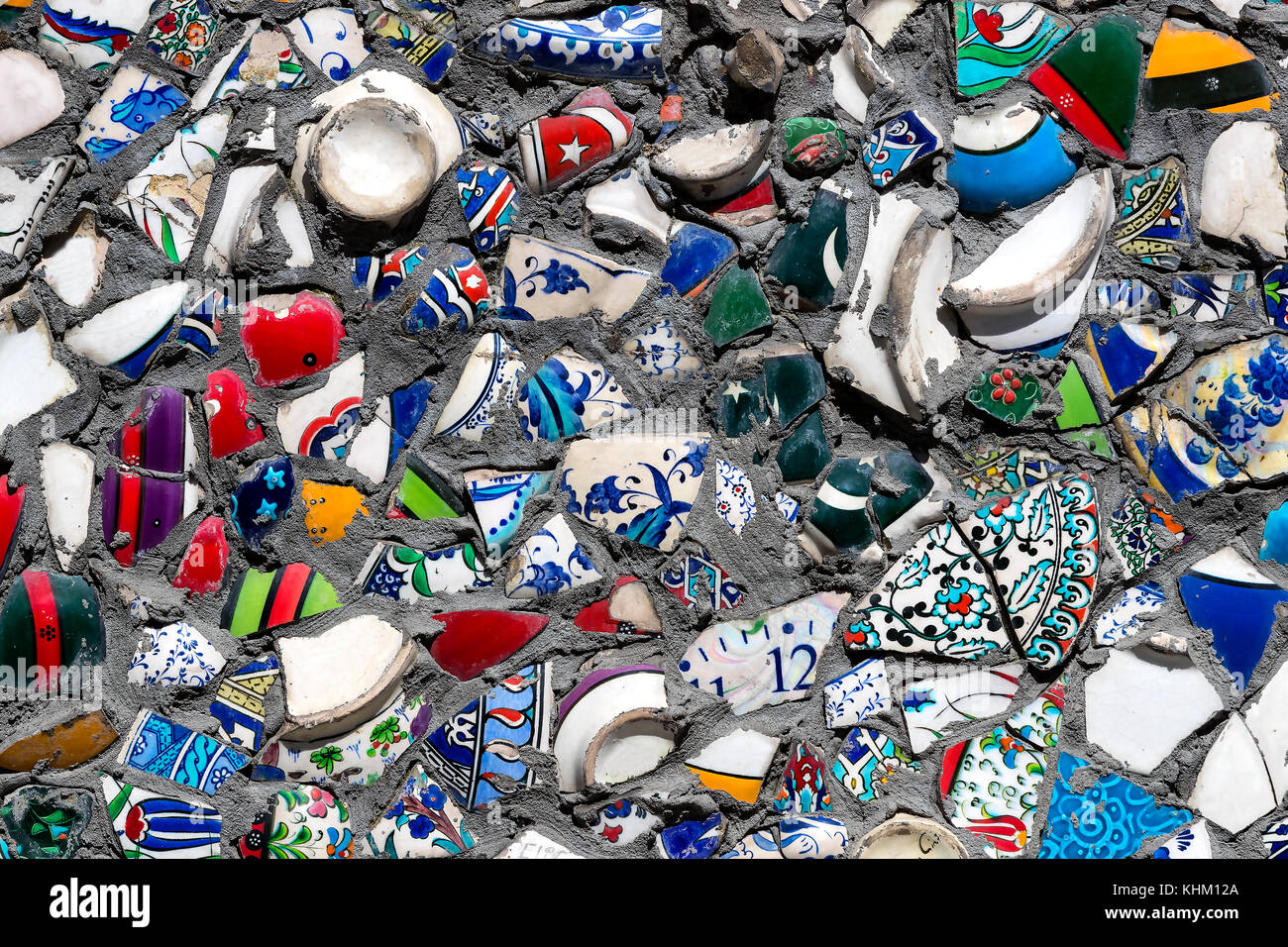 Wall with broken ceramic plates colored fragments Stock Photo - Alamy