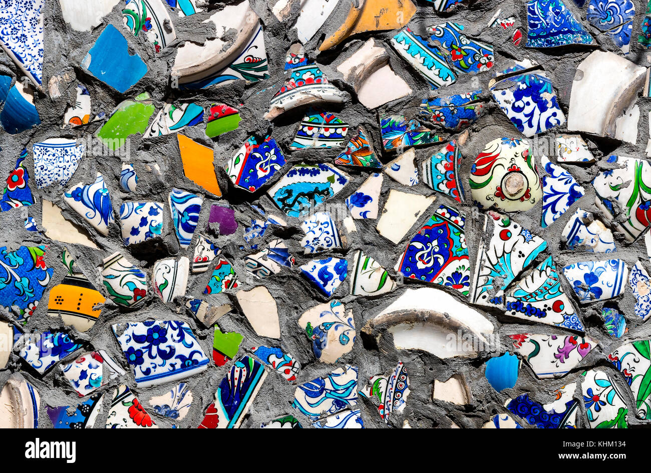 Wall with broken ceramic plates colored fragments Stock Photo - Alamy