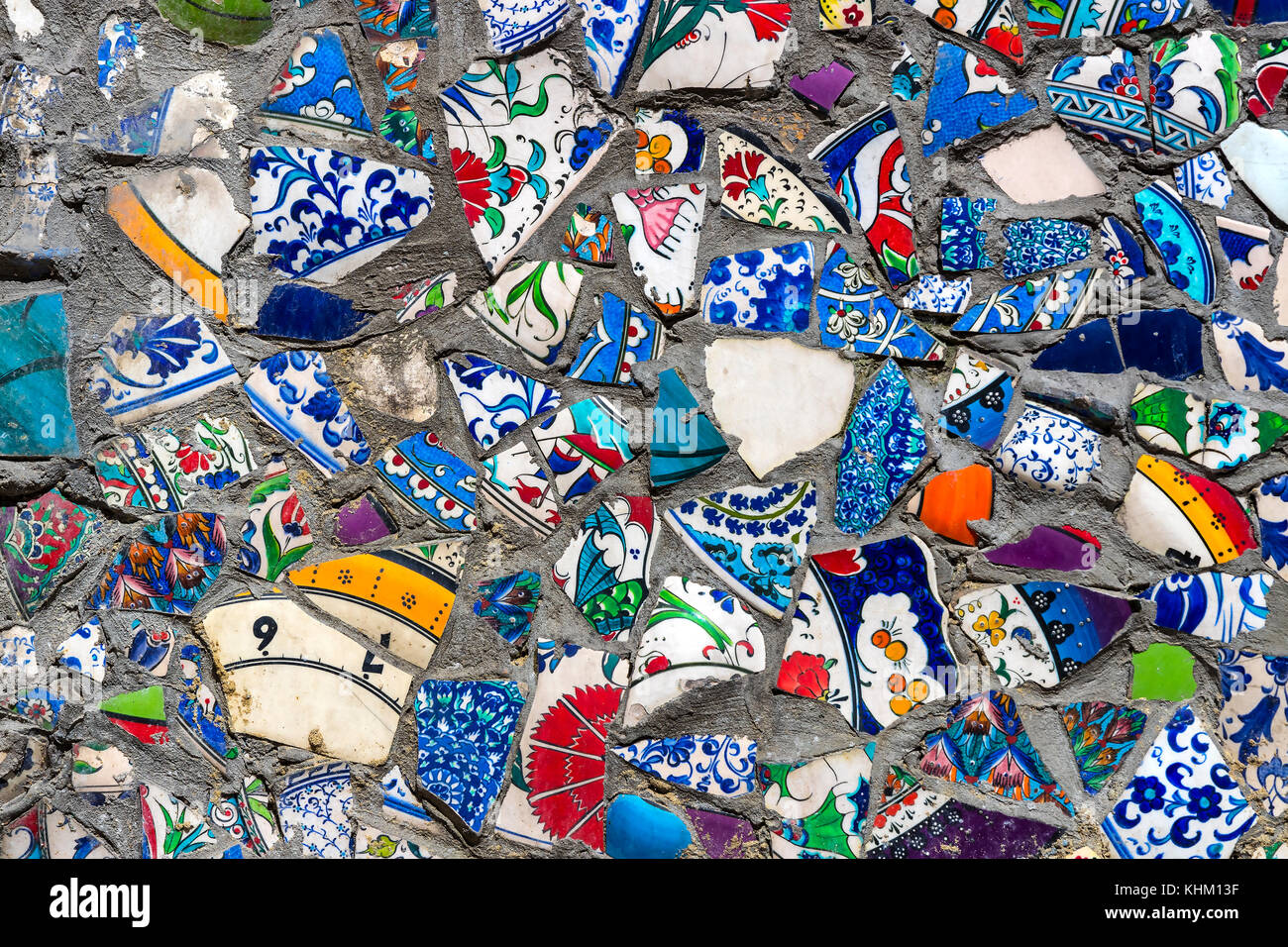 Wall with broken ceramic plates colored fragments Stock Photo - Alamy