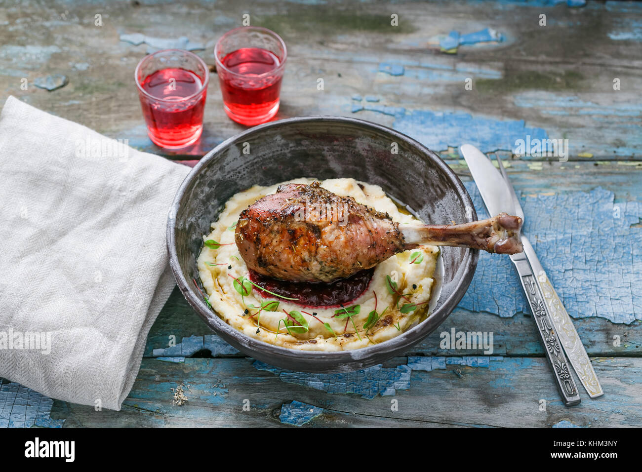 Dinner with baked turkey leg with cranberry sauce on mashed celery root ...