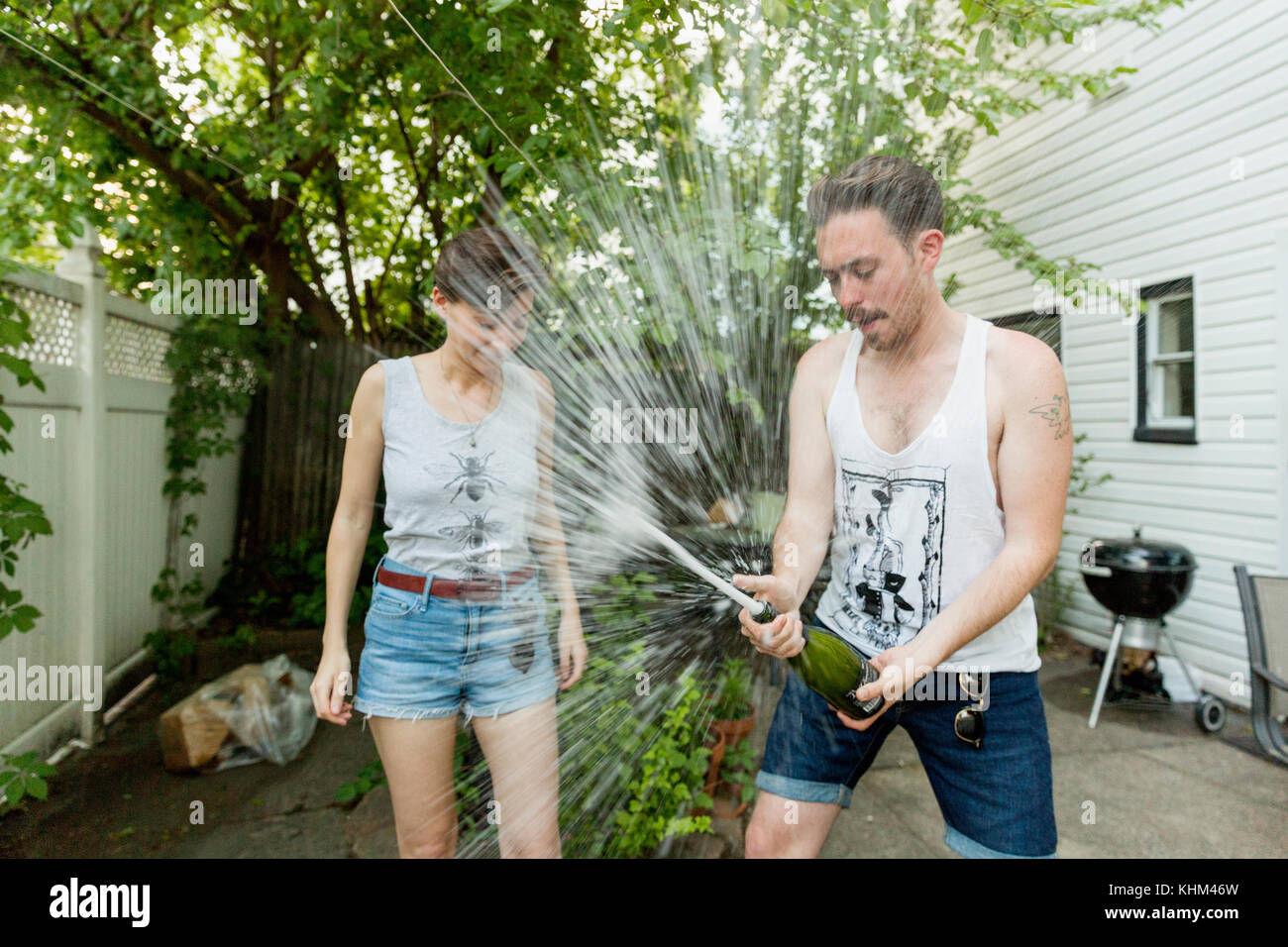 Young couple spraying champagne Stock Photo - Alamy