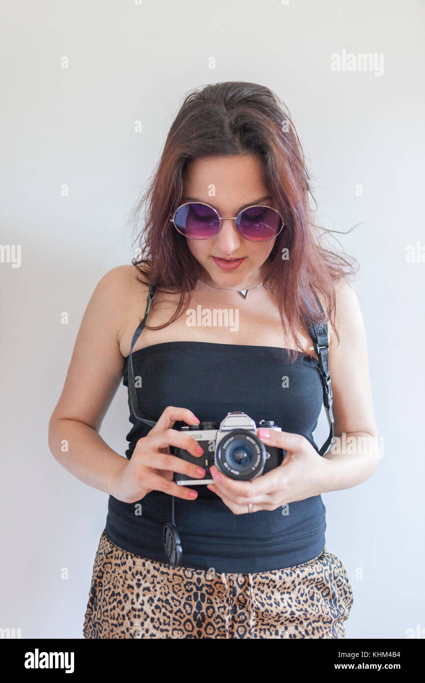 Portrait of a young woman with a camera Stock Photo - Alamy