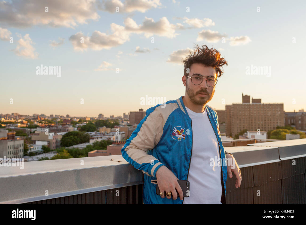 Young man on a rooftop Stock Photo - Alamy