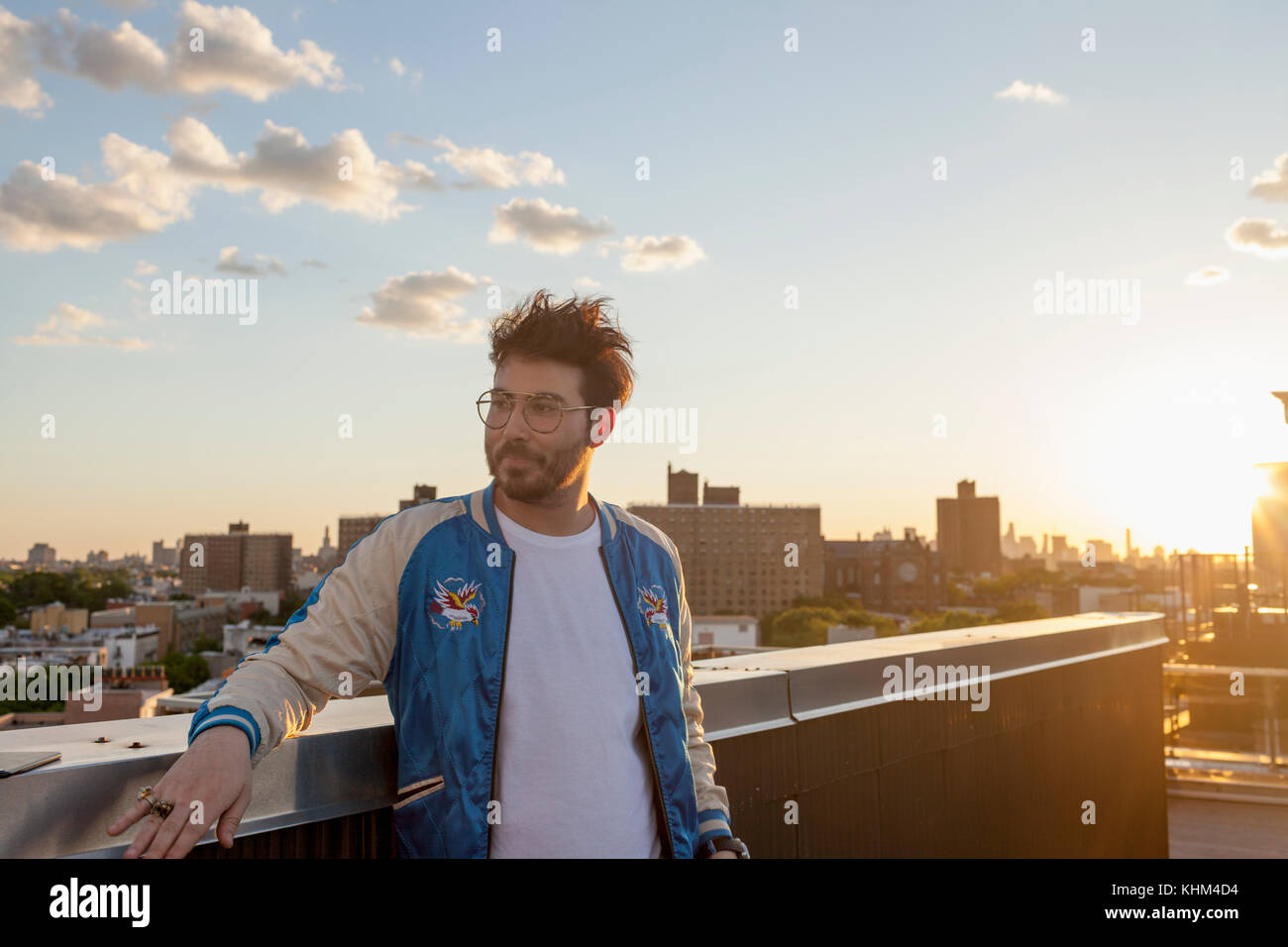 Young man on a rooftop Stock Photo - Alamy