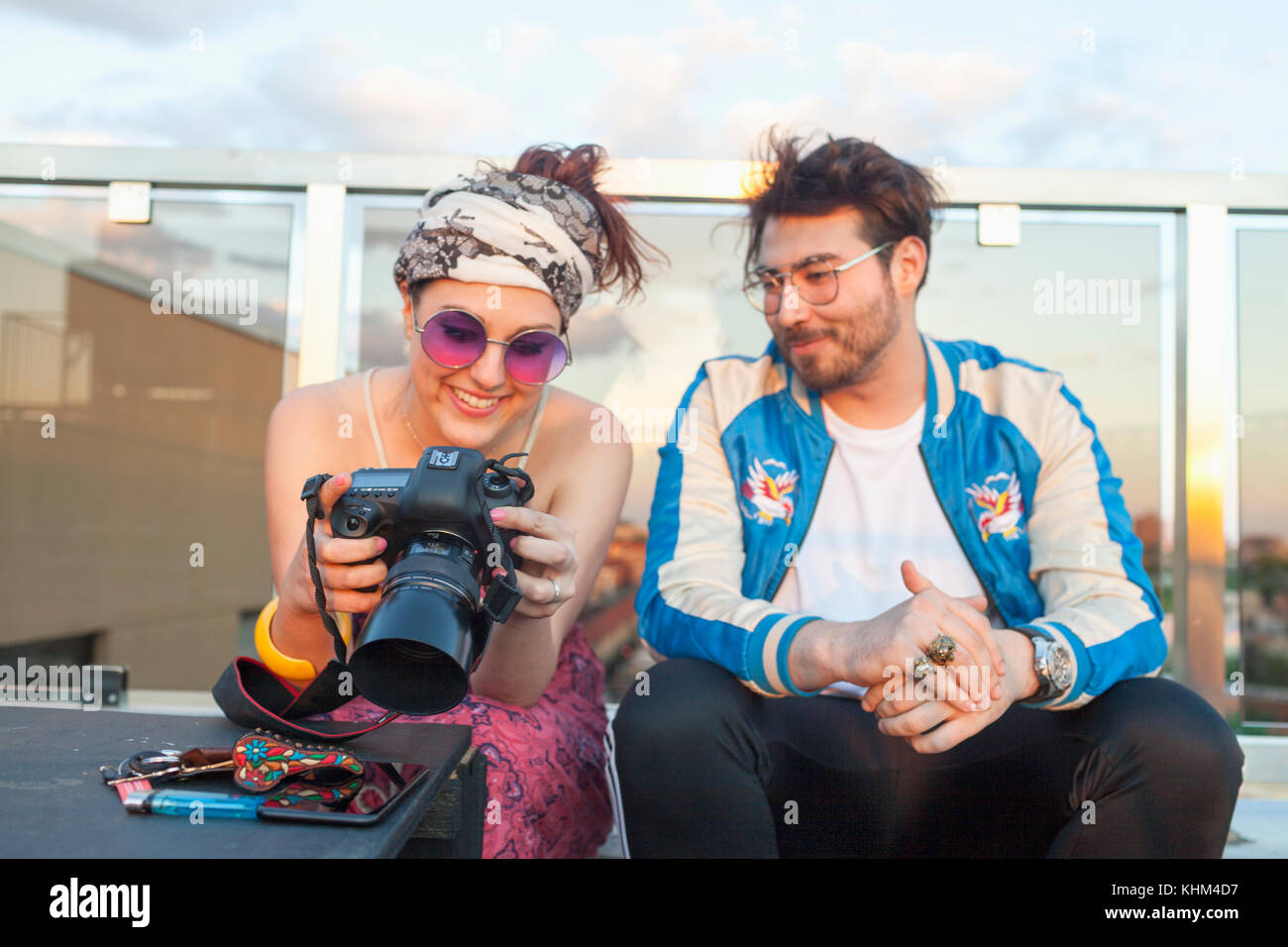 Young woman showing pictures to her friend Stock Photo - Alamy