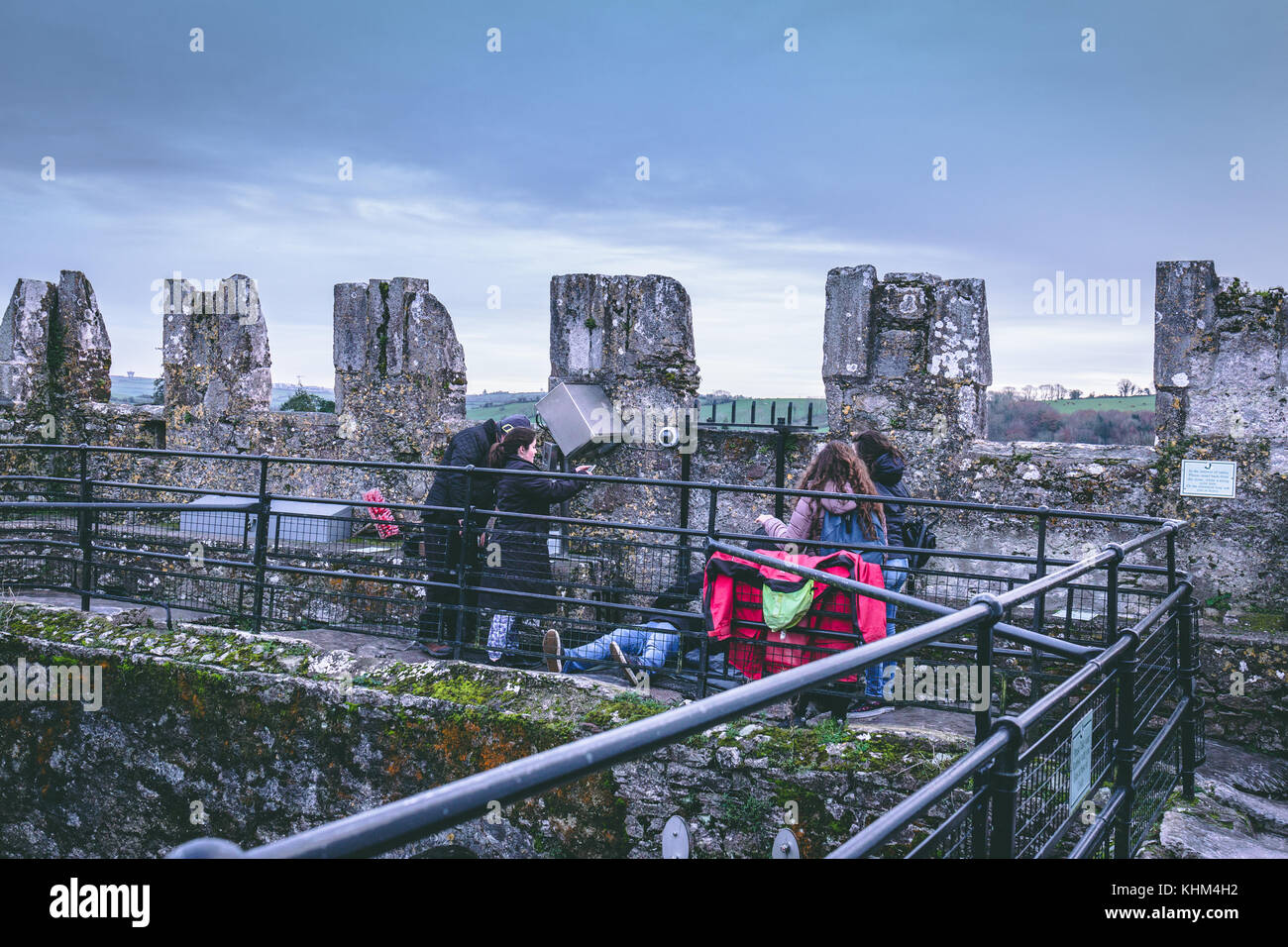 Tourists kissing the famous Blarney stone at Blarney Castle, a medieval ...