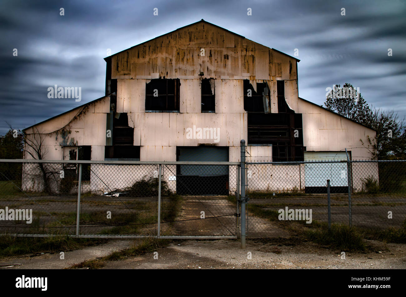 Empty war time factory in disrepair behind a chain link fence Stock ...
