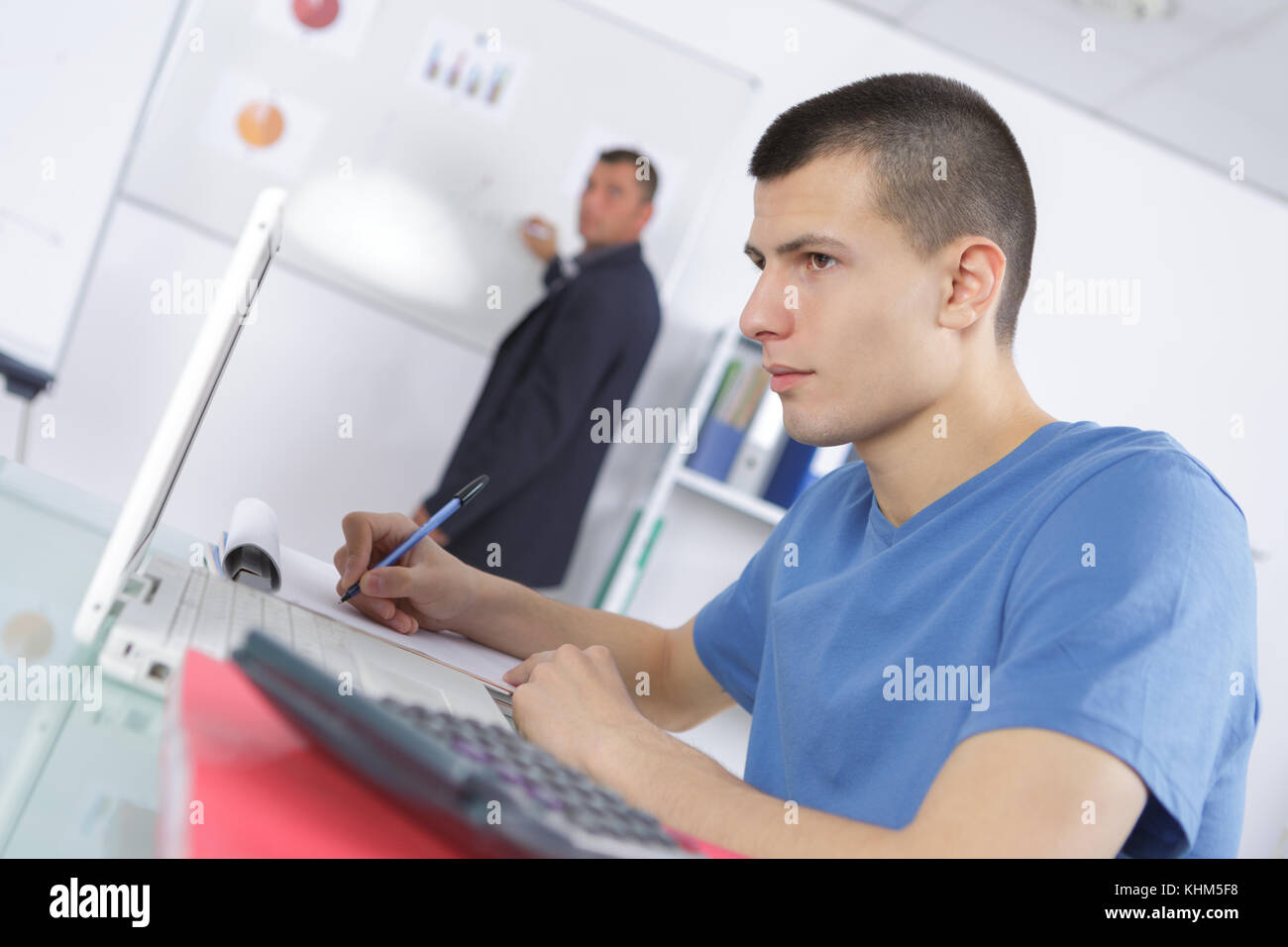 tutor near whiteboard screen giving lesson Stock Photo - Alamy
