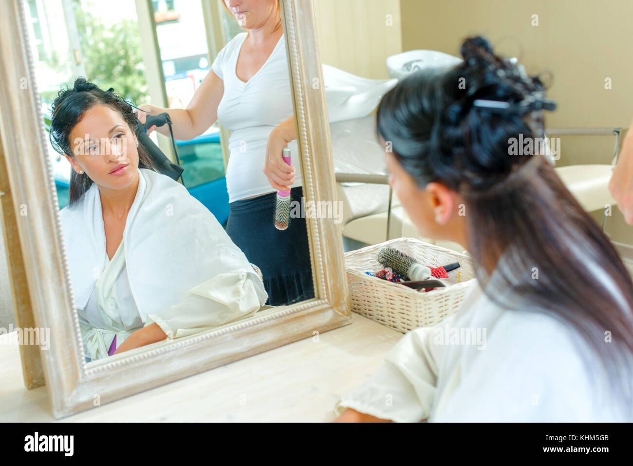 Checking her hair at the hair salon Stock Photo - Alamy
