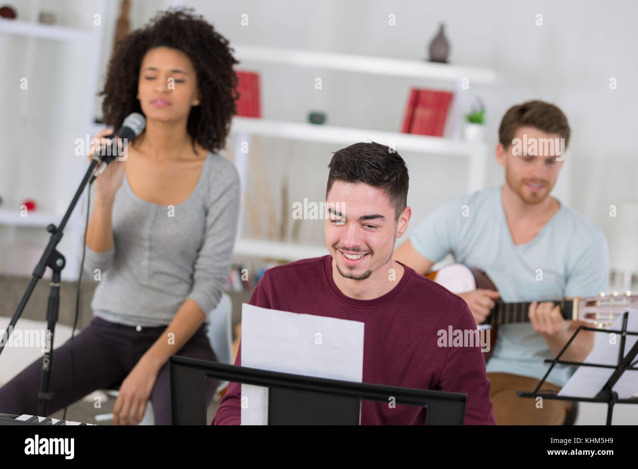 friends having fun at home singing a song together Stock Photo - Alamy