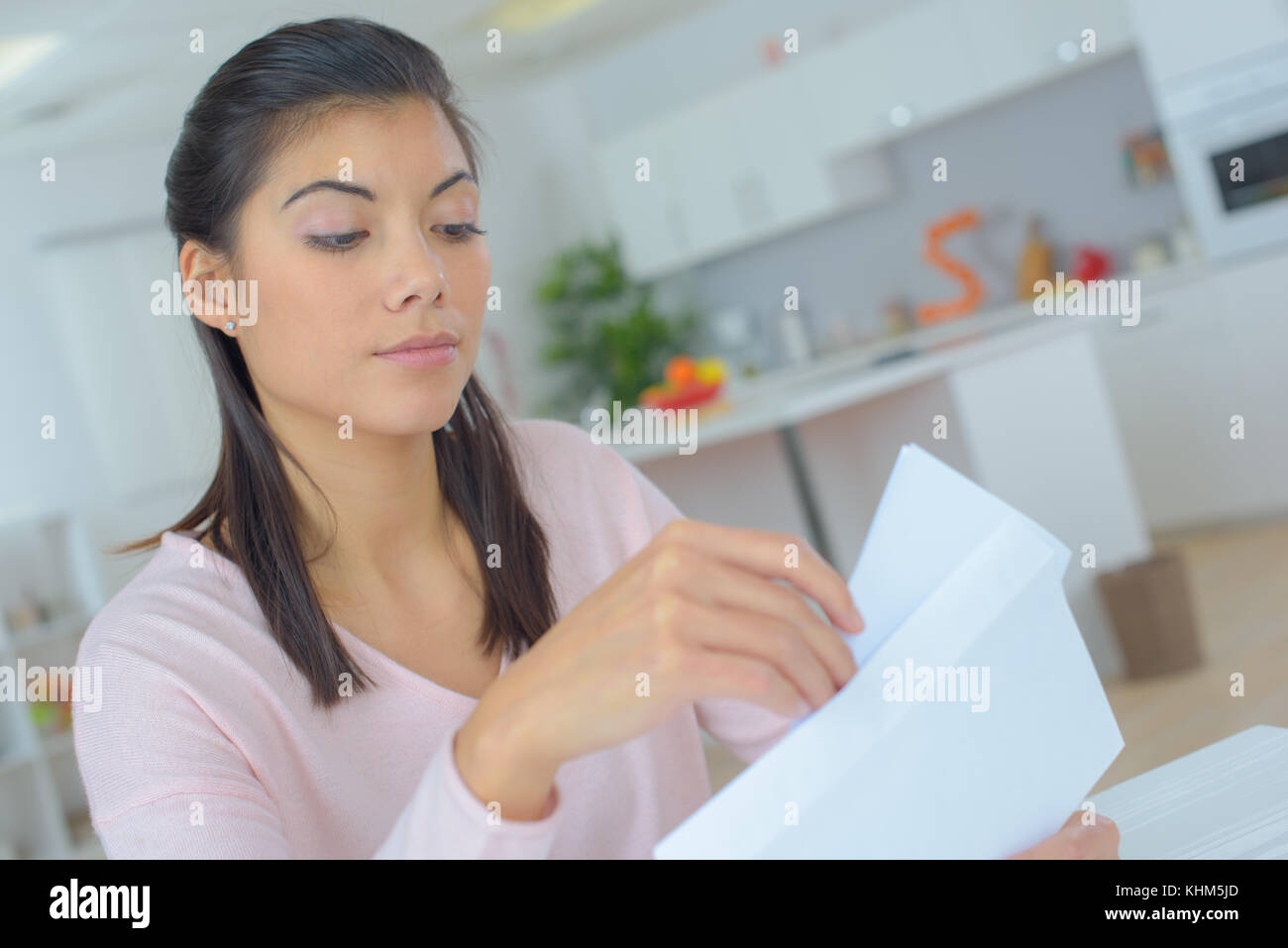 Lady putting letter into envelope Stock Photo - Alamy