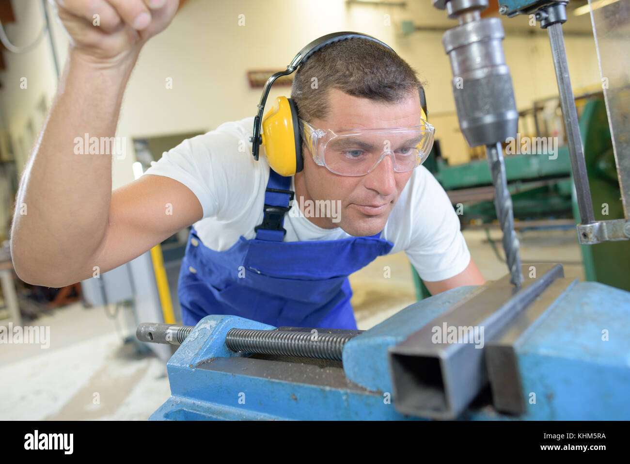 Engineer using bench drill Stock Photo - Alamy