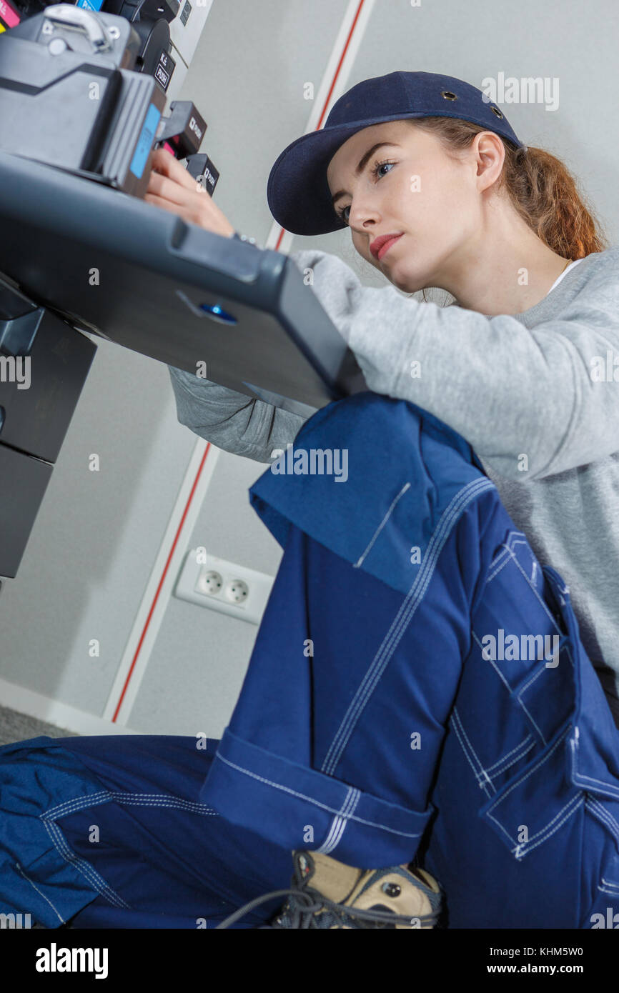young woman repairing photocopier Stock Photo - Alamy