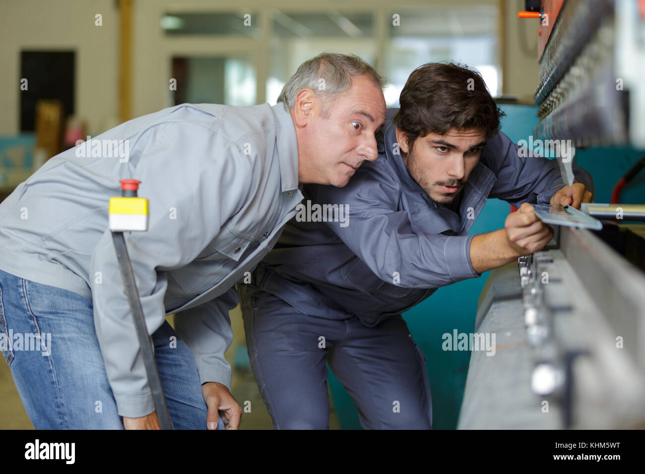 two workers workers together Stock Photo - Alamy