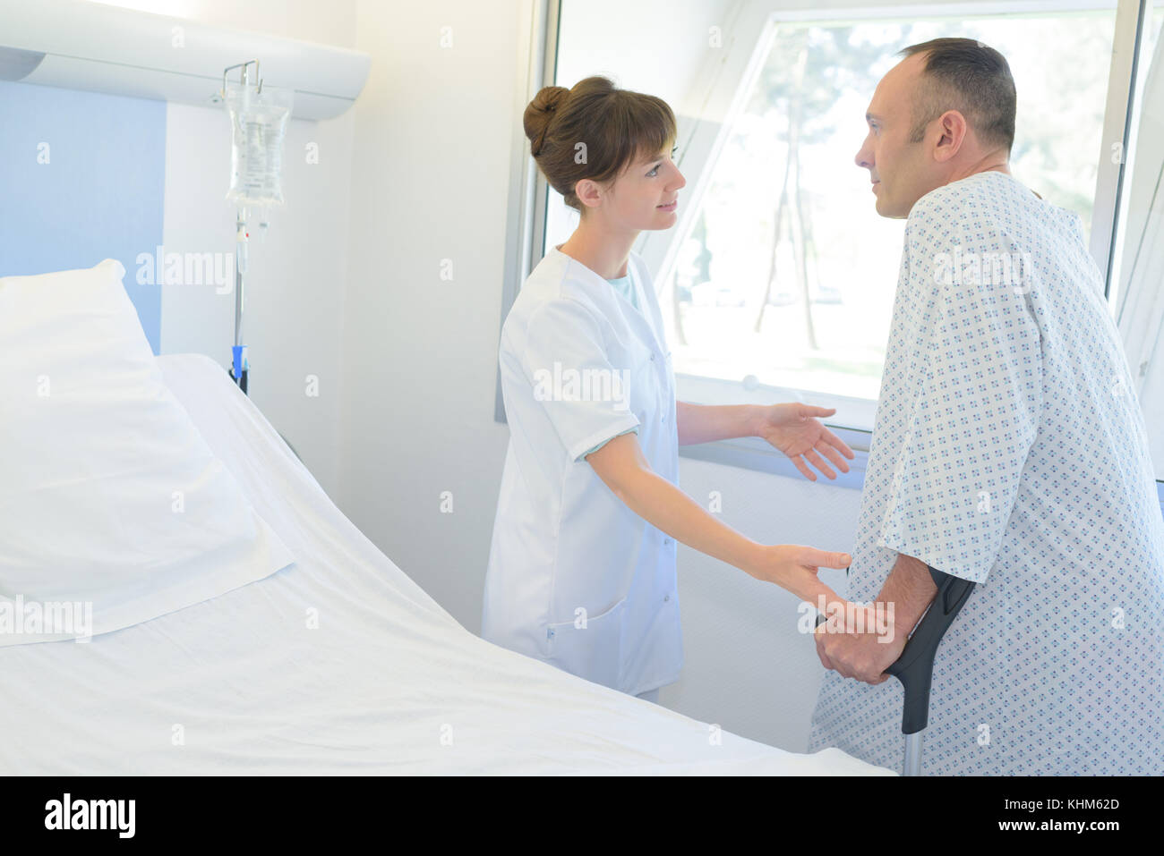 female nurse taking to patient Stock Photo - Alamy