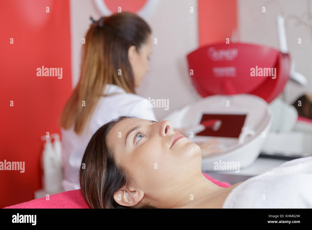 woman receiving medical hair beauty treatment at cosmetology center ...