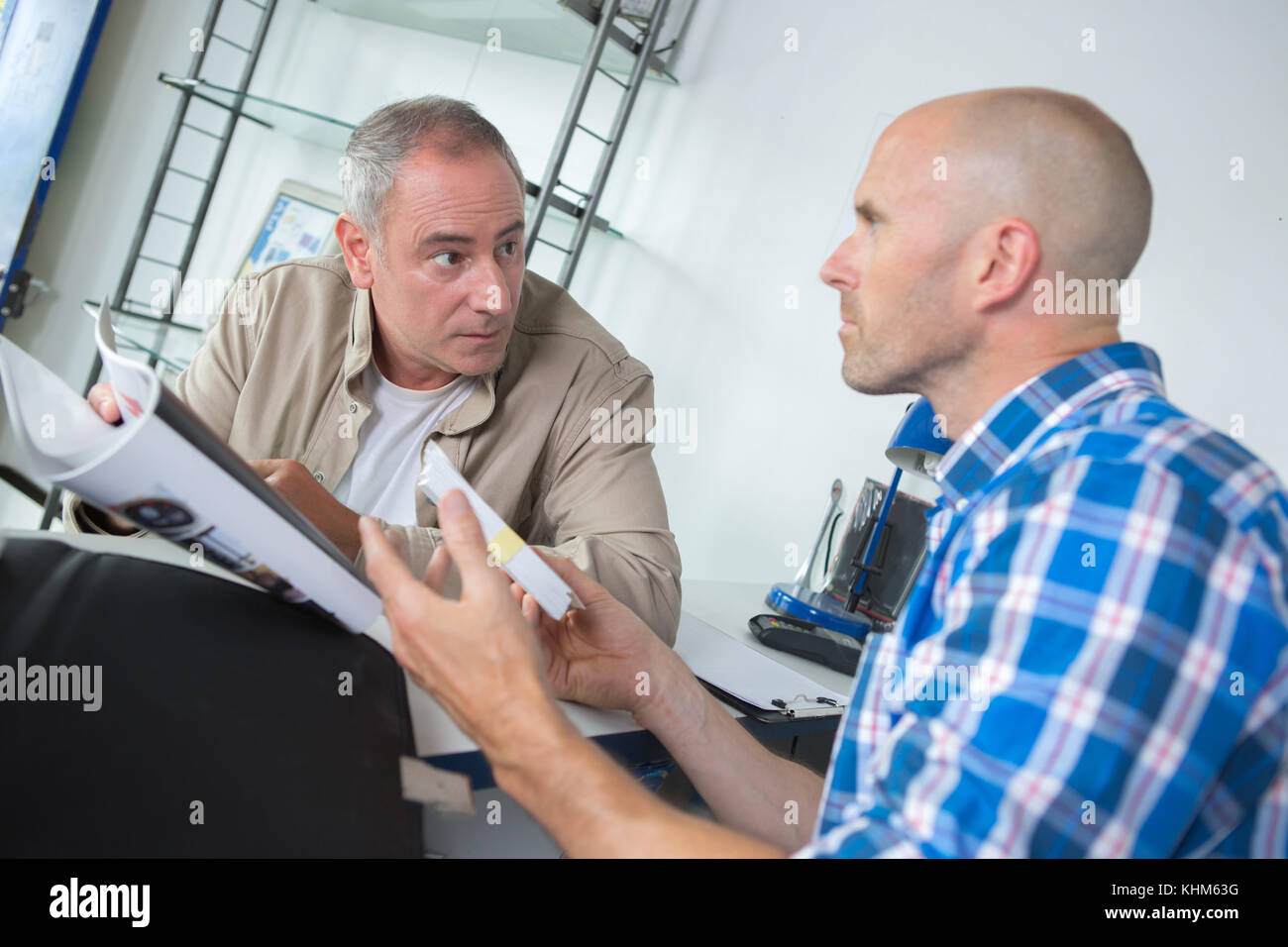 two attractive men talking in office Stock Photo - Alamy