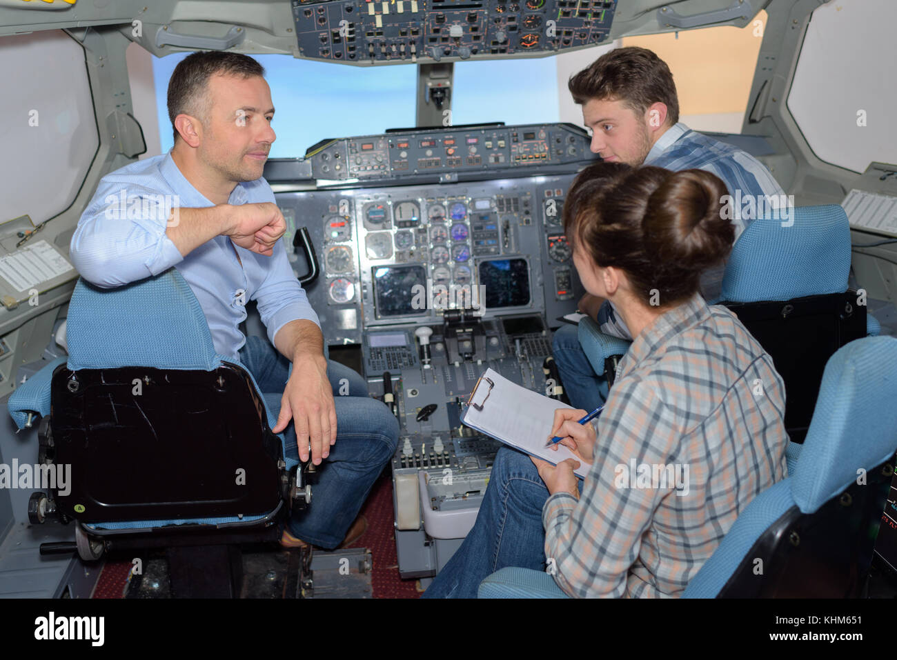 Three people in aircraft cockpit Stock Photo - Alamy