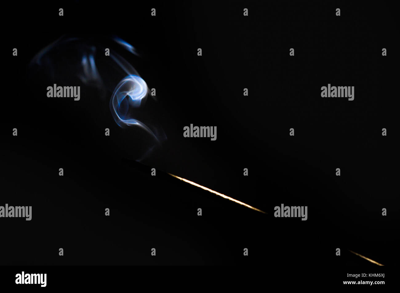 Photograph of an Incense bar and smoke on dark background Stock Photo ...