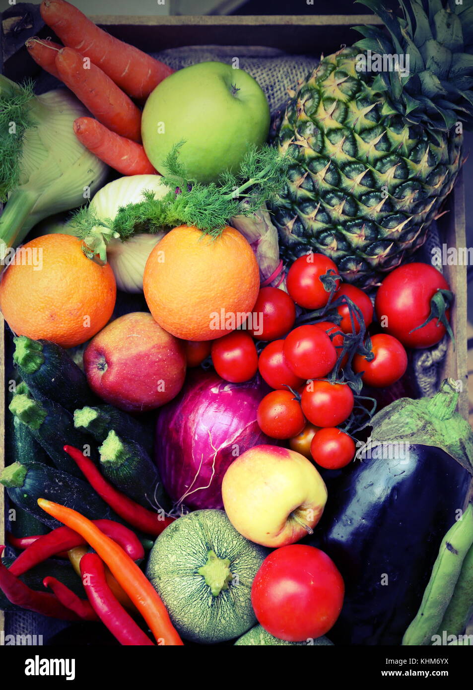 basket with fresh fruits and vegetables like pineaple,carrots,apples ...