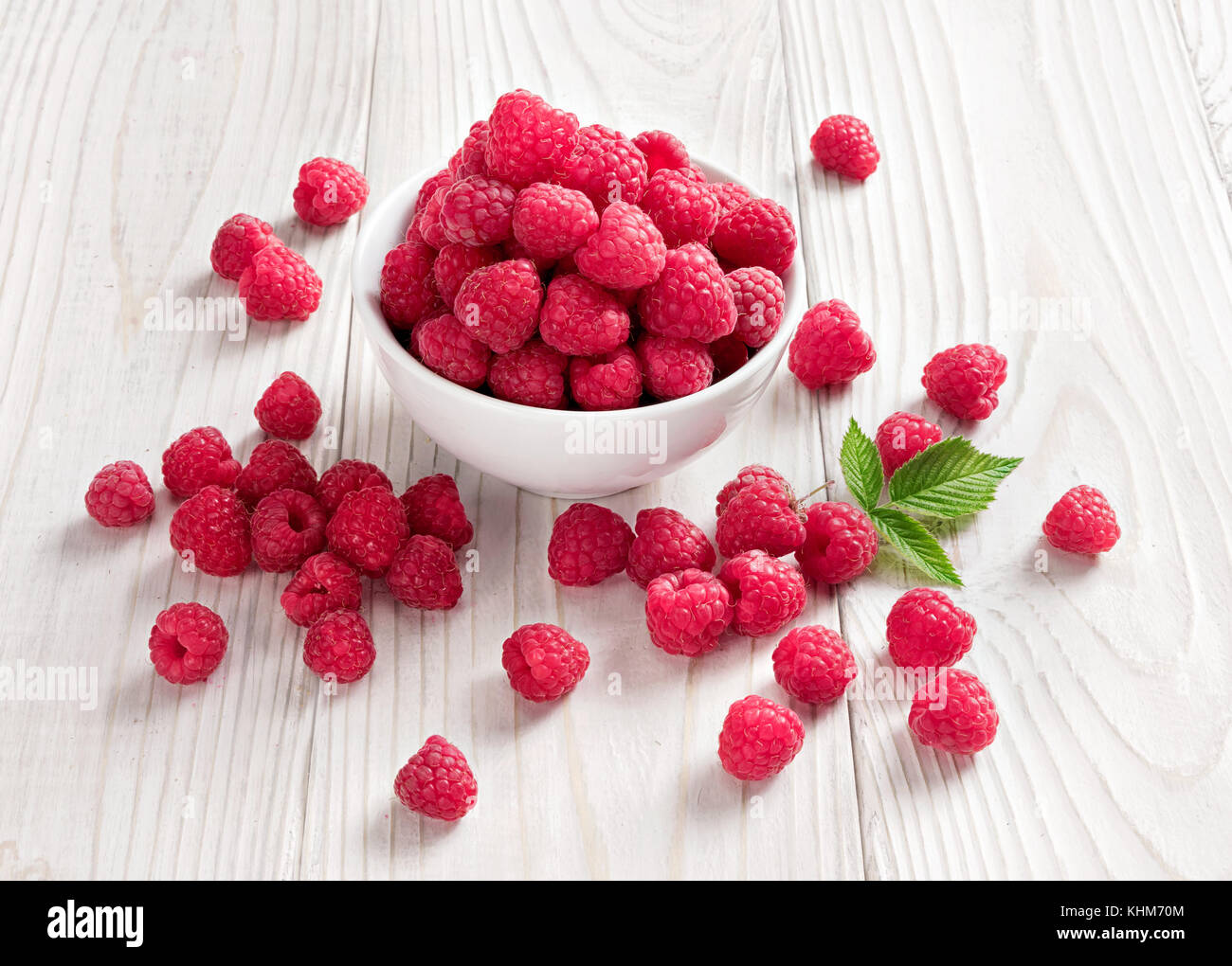 Sweet raspberries in bowl on wooden table. Close up, high resolution ...