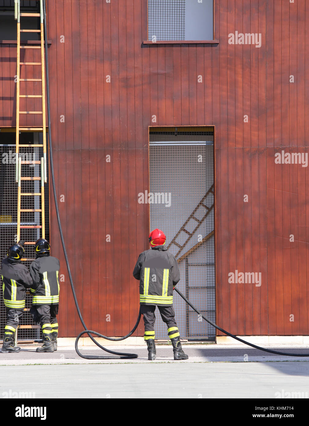 firefighters in the fire brigade with a long staircase during anti-fire ...