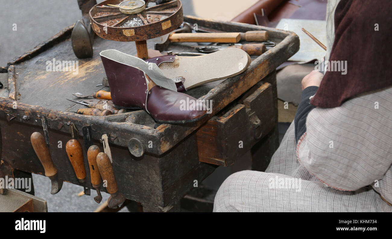 old broken leather shoe in the shoemaker's shop Stock Photo - Alamy