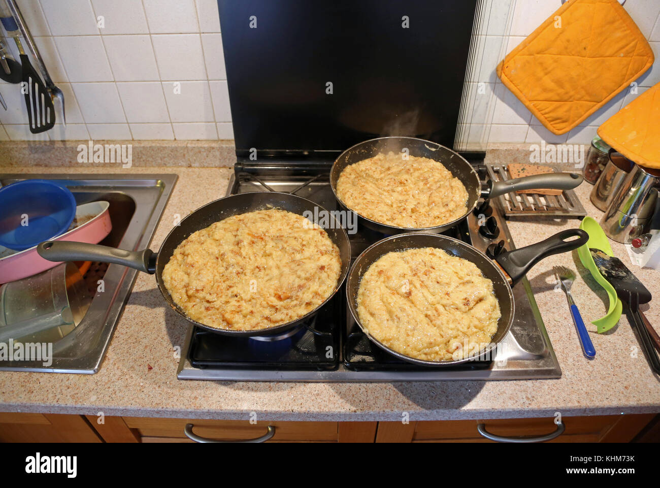 three big pans with the food named frico a typical italian dish with ...