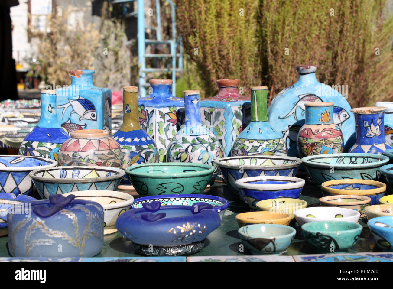 Blue ceramics on the table on the street of Bosra, Syria Stock Photo ...