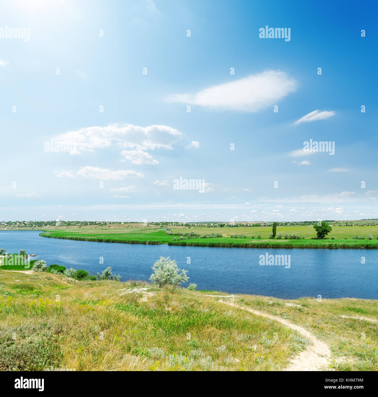 blue sky with clouds and sun over river Stock Photo - Alamy