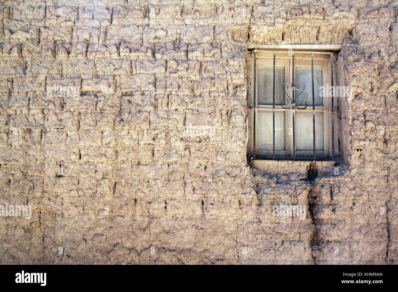 Mud wall and small window of house Stock Photo - Alamy