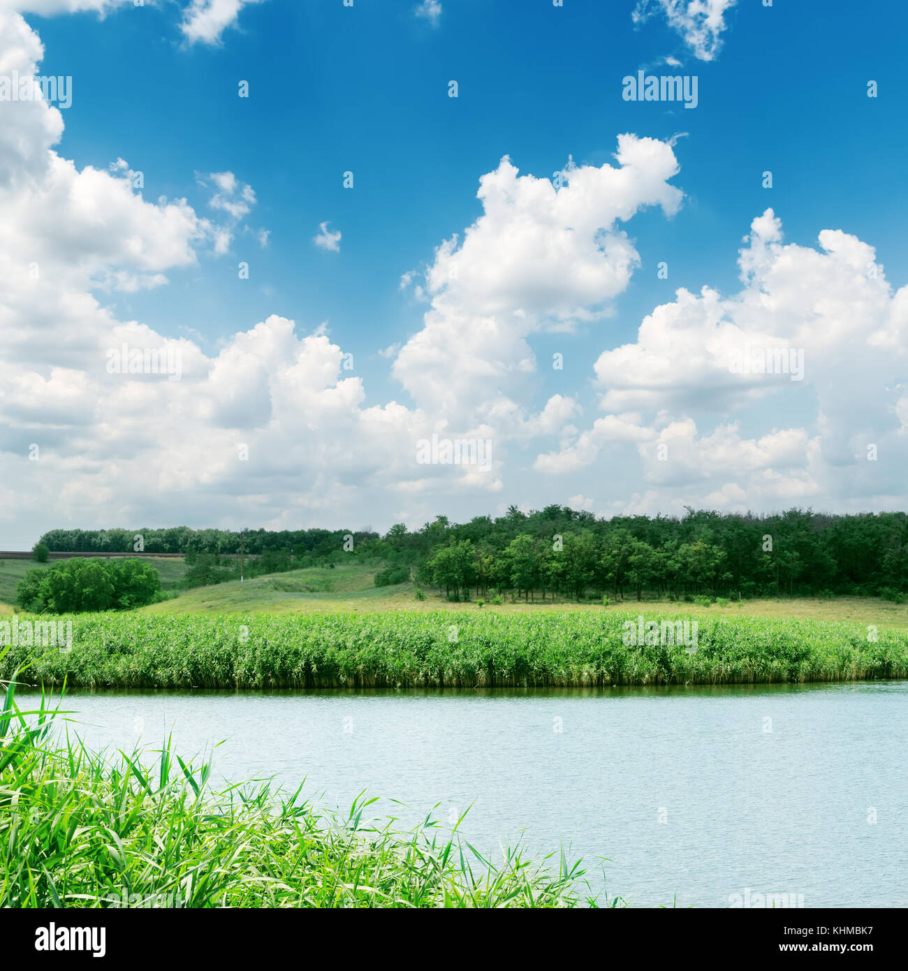 white clouds in blue sky over river Stock Photo - Alamy