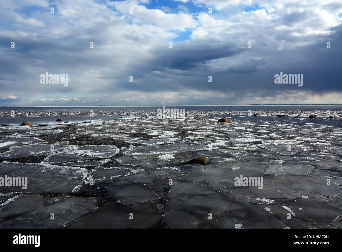 Frozen sea shore with stormy clouds and broken ice Stock Photo - Alamy