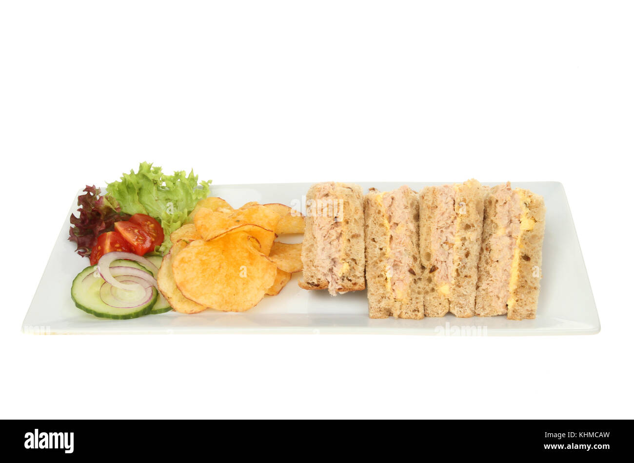 Tuna mayonnaise sandwiches with potato crisps and salad on a ...