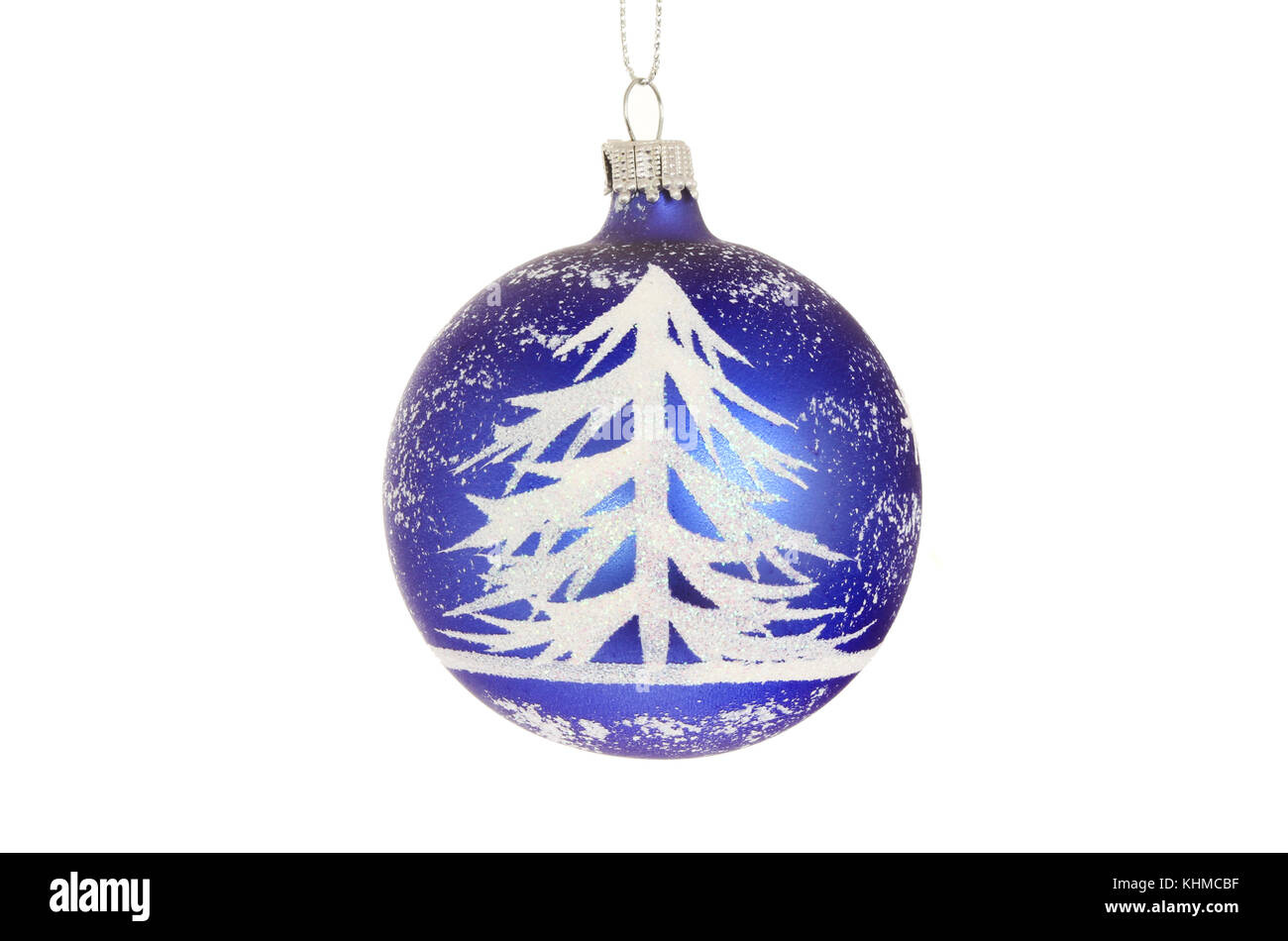 Blue Christmas bauble with a snowy fir tree isolated against white ...