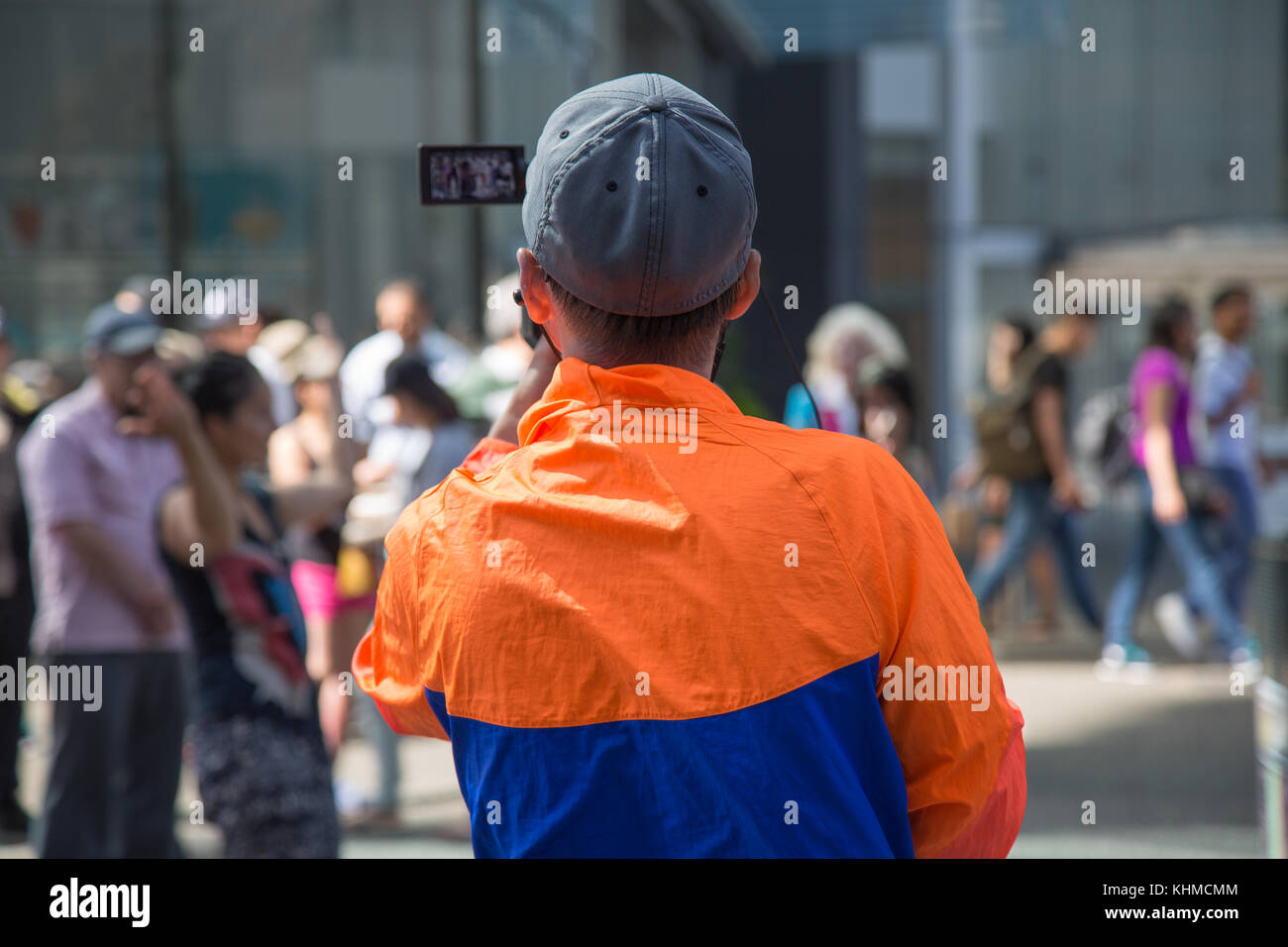 Videographer reporter male filming camera event street Stock Photo - Alamy
