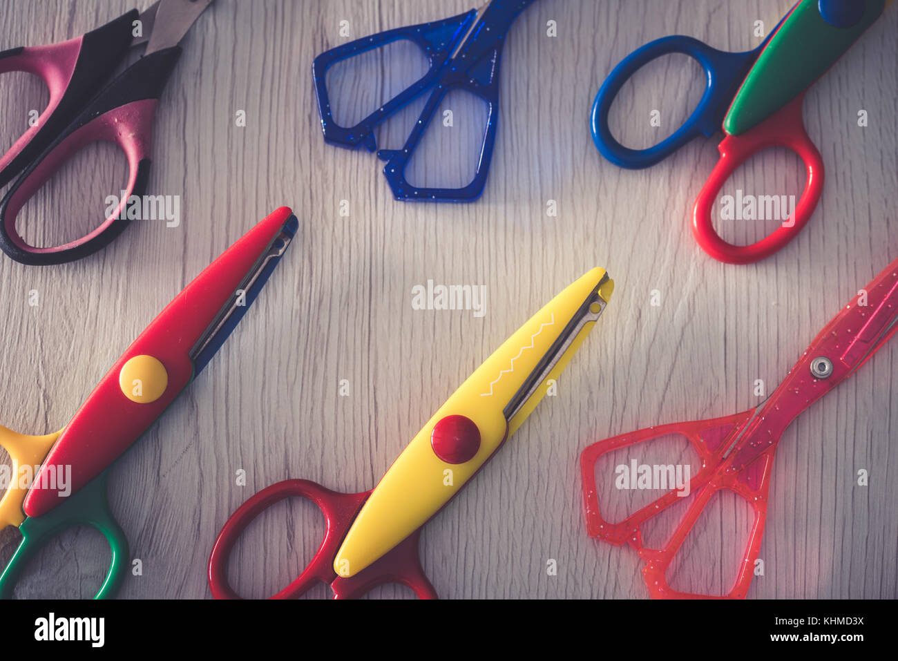 Colorful scissors lined up in a row on a white wooden background Stock ...