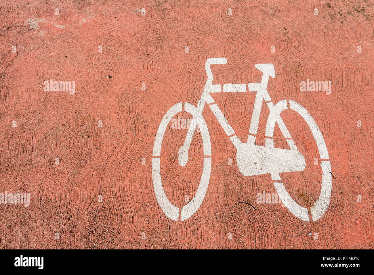 Cycling sign marking on red concrete asphalt Stock Photo - Alamy