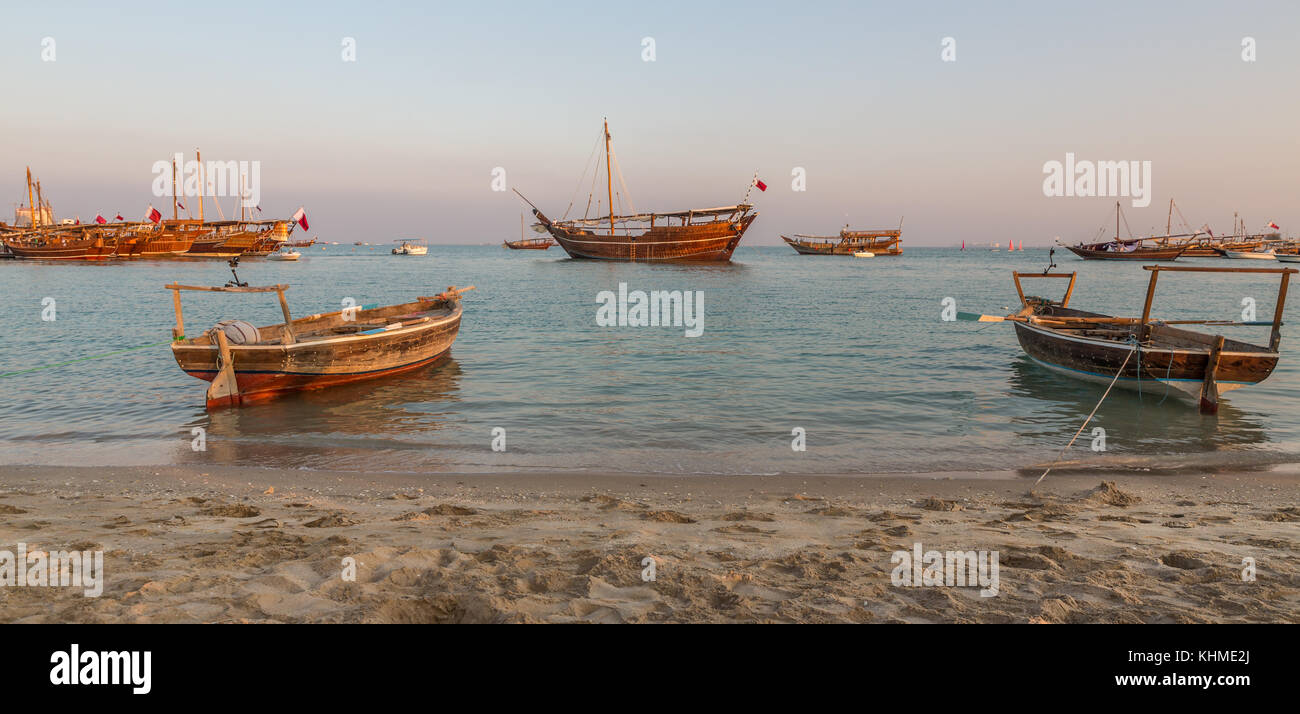 Traditional wooden boats (dhow) with Qatari flag in Katara beach, Doha ...