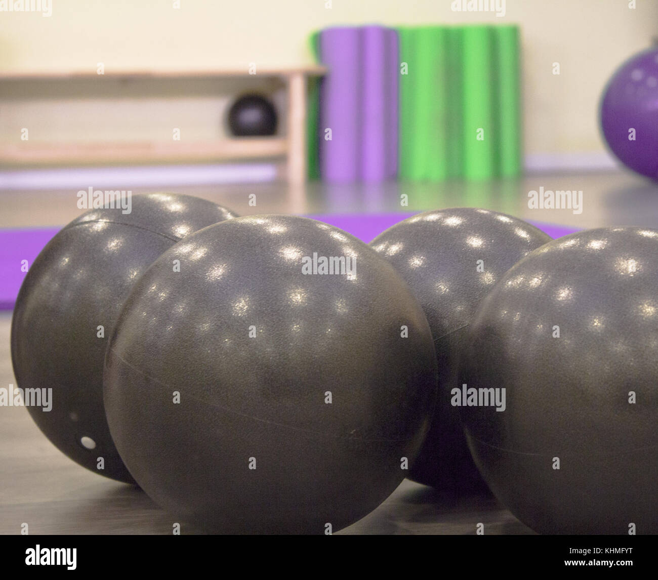 Medium size black balls for pilates exercises Stock Photo - Alamy