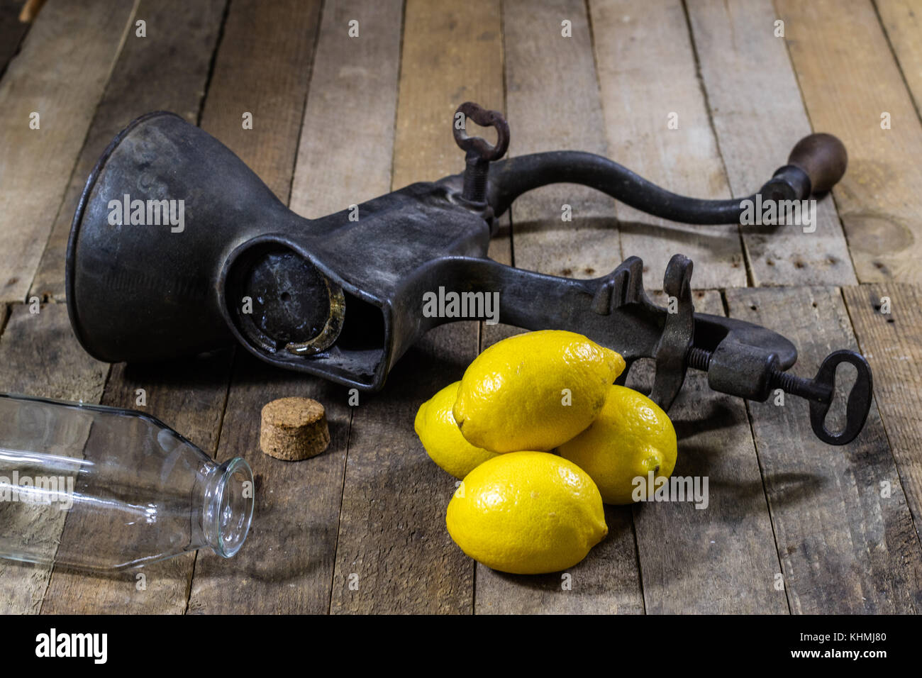 old cast iron juice machine on a wooden kitchen table. Lemon juice and ...