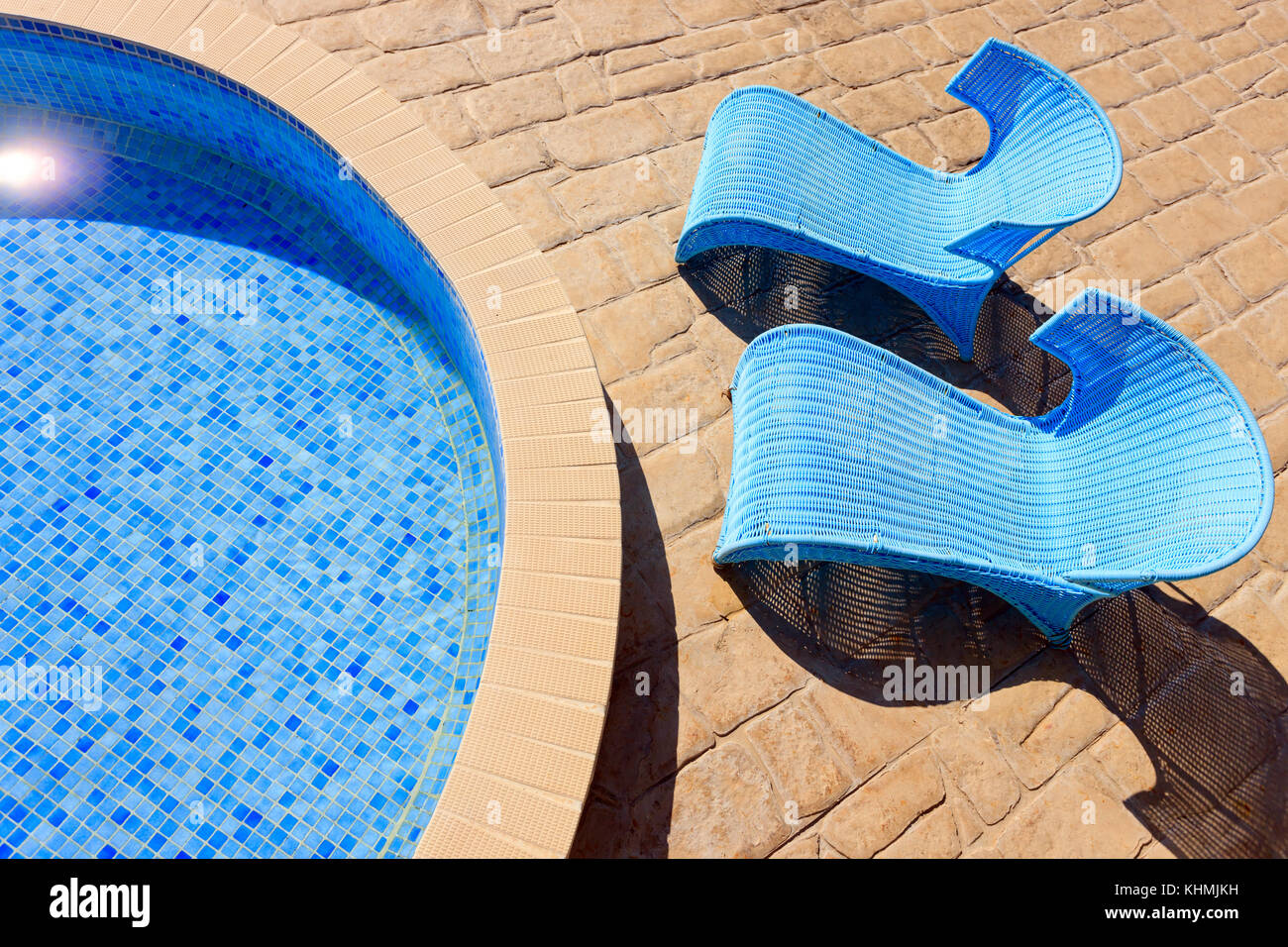 closeup of a small pool with blue stylish sunbeds Stock Photo - Alamy