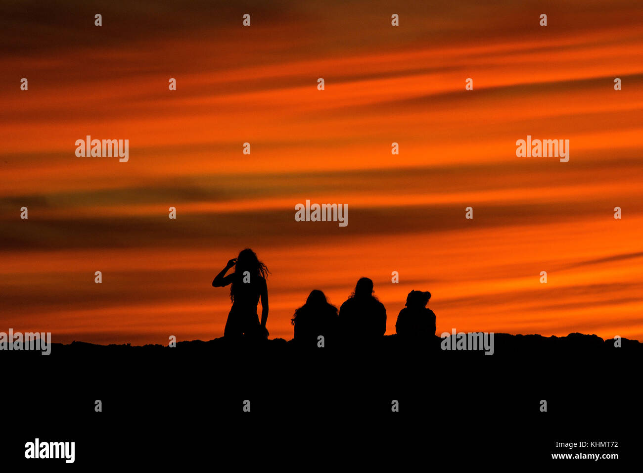 Venice, California, USA. 17th Nov, 2017. People sit on a sand berm ...
