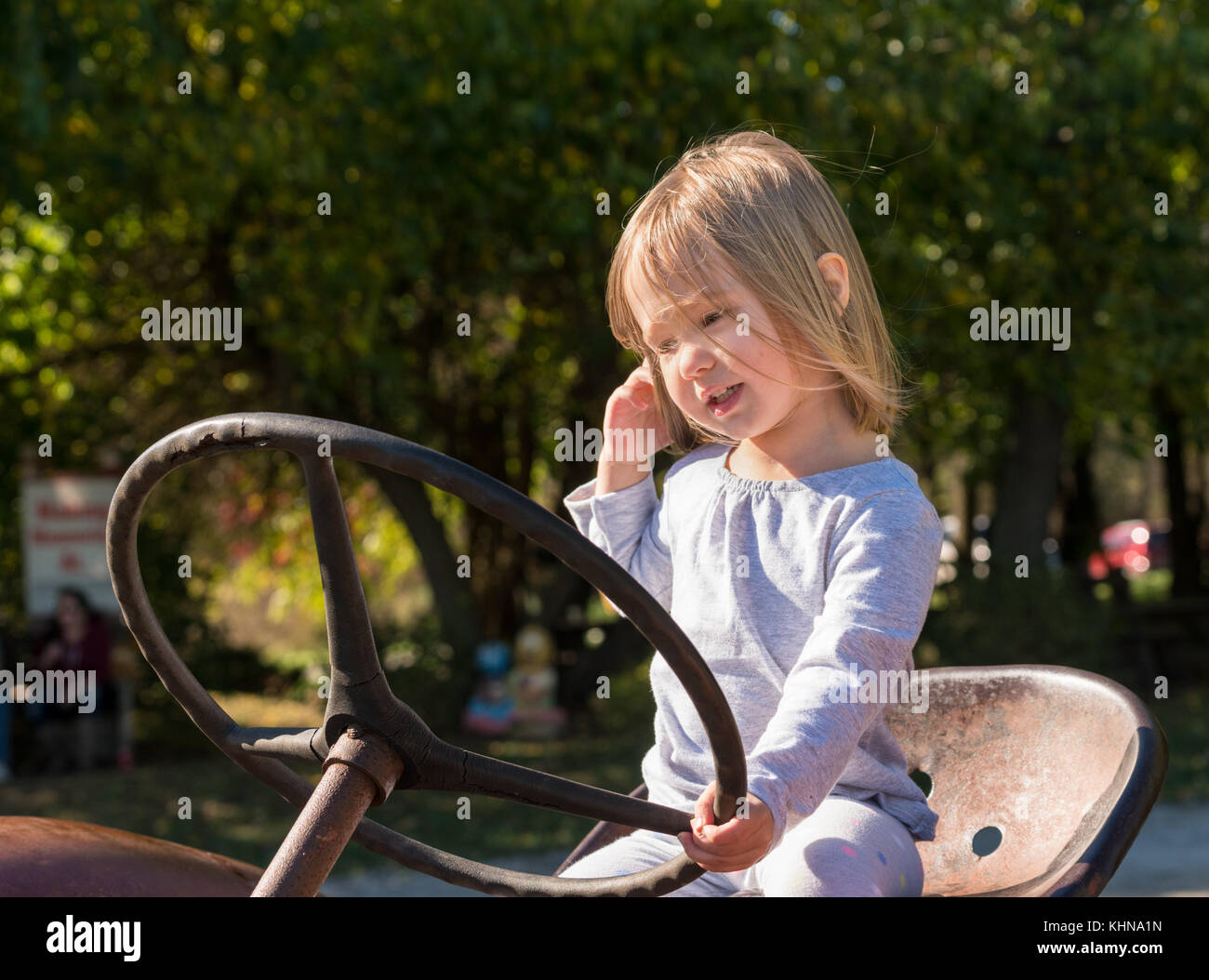 Young girl driving an old tractor on farm Stock Photo - Alamy